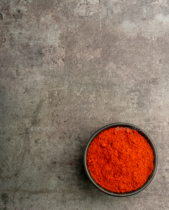 Red Paprika Powder from a flat lay angle with a dramatic dark ...