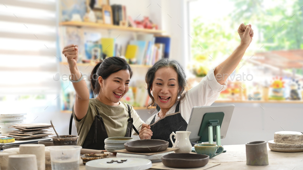 Happy craft pottery shop owners celebrating for sales success after ...