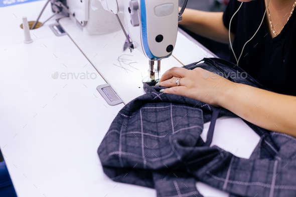 Tailor working on electric sewing machine Stock Photo by collab_media