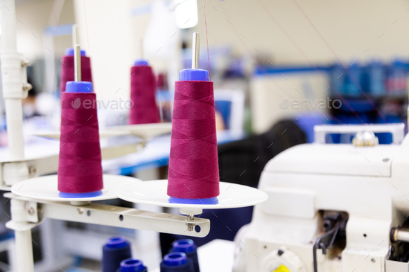 Purple spool of sewing threads unrolling on sewing machine Stock Photo ...