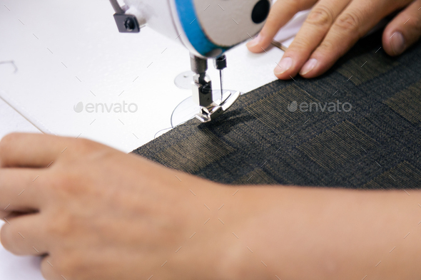 Tailor working on electric sewing machine Stock Photo by collab_media