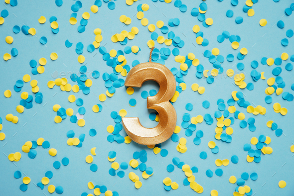Number 3 three golden celebration birthday candle on yellow and blue ...