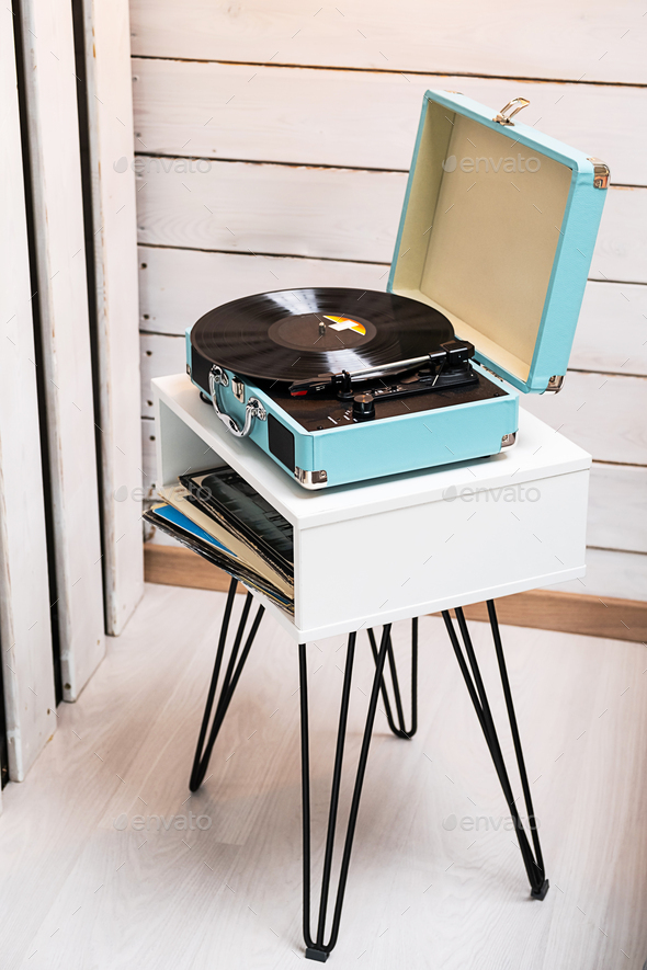 Analog vinyl record player with disc on white table. Modern turntable ...