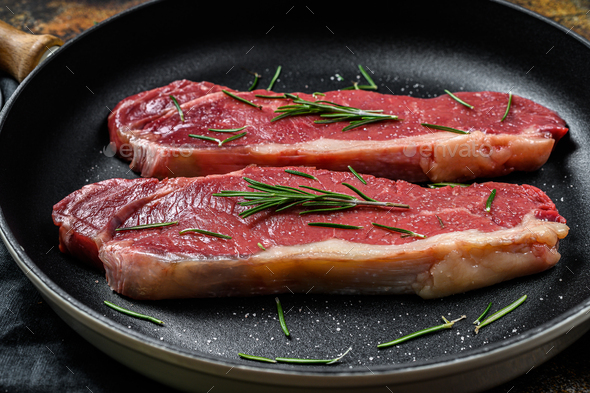 Raw ramp steak, fresh meat, marbled beef. Dark background. Flat lay ...