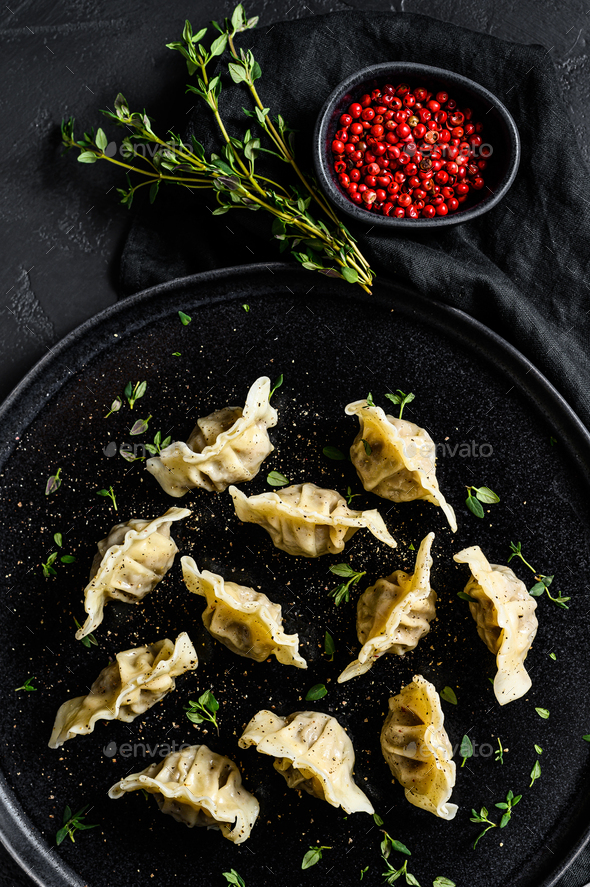 Japanese gyoza stuffed with meat. Black background. Top view Stock ...