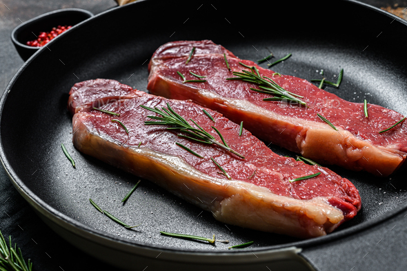 Raw ramp steak, fresh meat, marbled beef. Dark background. Flat lay ...