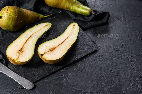 Pears and pear halves. Farm eco fruits. Black background. Top view ...