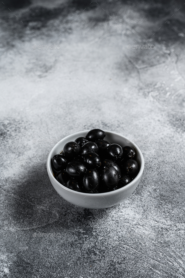 Seedless black olives. Gray background. Top view. Space for text Stock ...