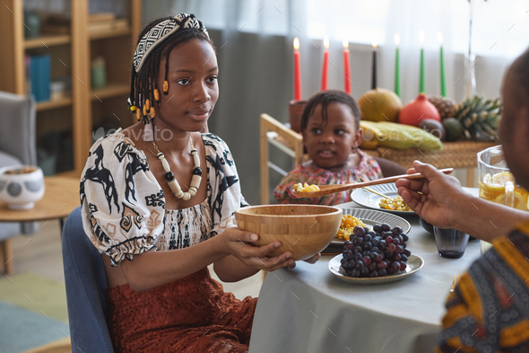 Family eating traditional food at dining table Stock Photo by ...