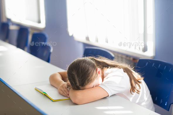 student sleeps at lesson in classroom of school. problem of regime of ...