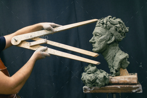 Man sculptor creates sculpt bust clay human woman sculpture. Statue ...