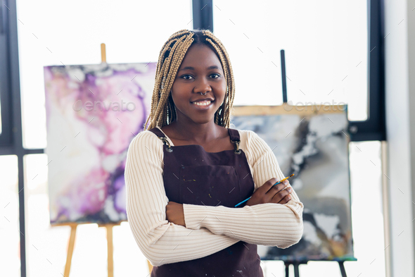 african american woman student in art class inspired and painting Stock ...