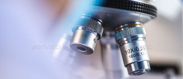 Scientist analyzing microscope slide at laboratory, technician ...