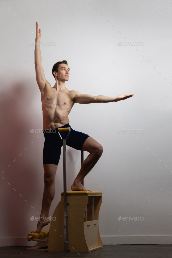 Pilates reformer chair man fitness yoga gym exercise. Stock Photo by ...