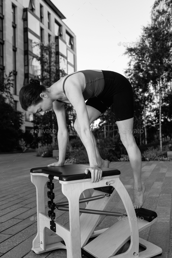Pilates reformer chair woman fitness yoga gym exercise. Stock Photo by ...
