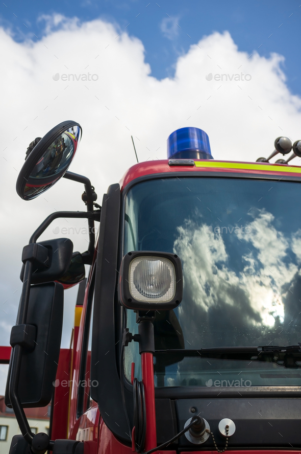 Fire engine with reflective sky and clouds on the windshield. Rescue ...