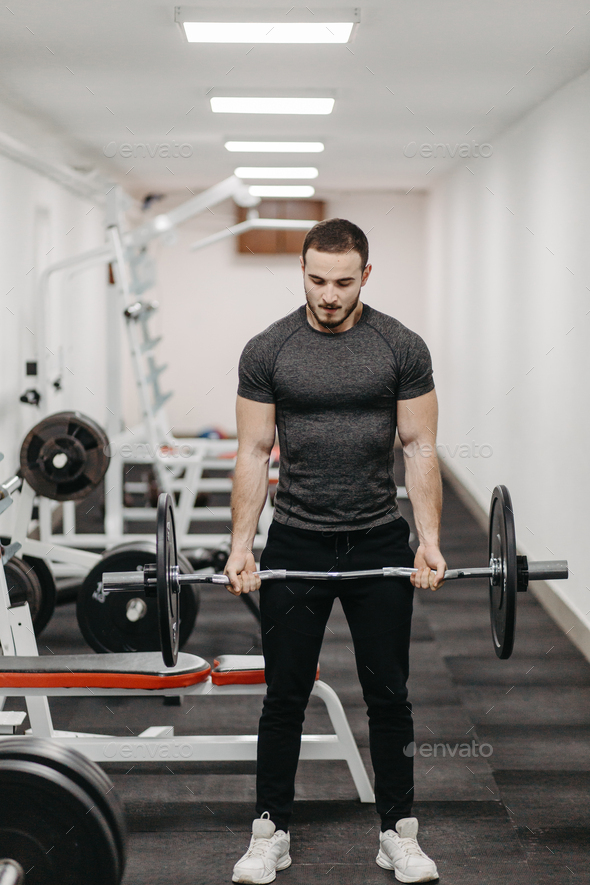 Young man trains his body to stay fit and have defined muscles. Stock ...