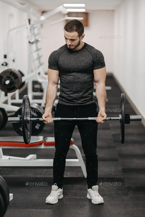 Young man trains his body to stay fit and have defined muscles. Stock ...