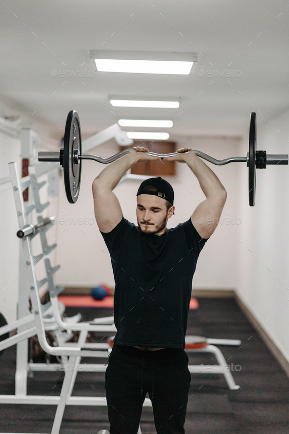 Young man trains his body to stay fit and have defined muscles. Stock ...