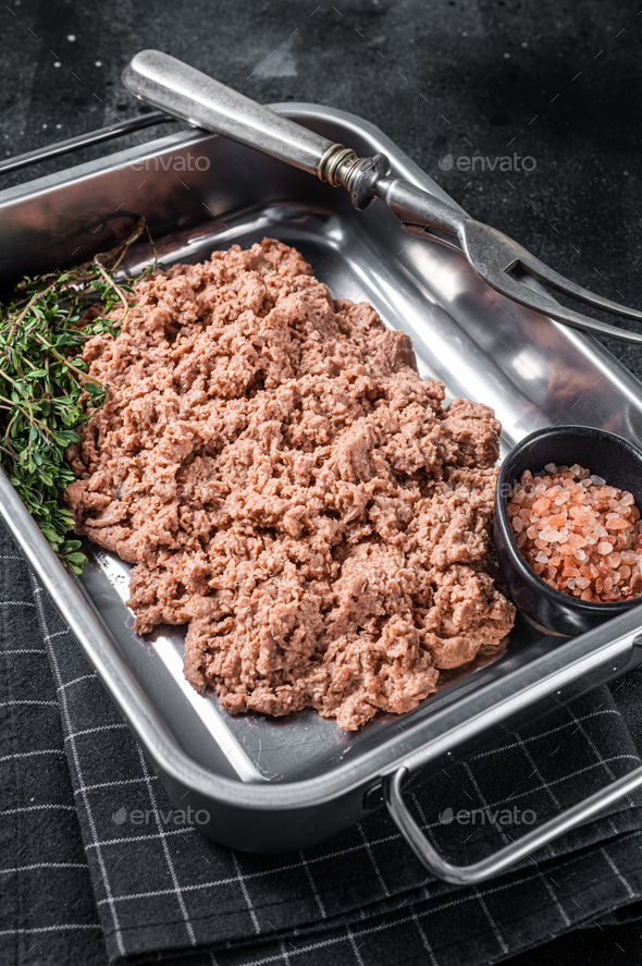 Vegetarian ground meat, raw plant based meat with herbs in kitchen tray ...