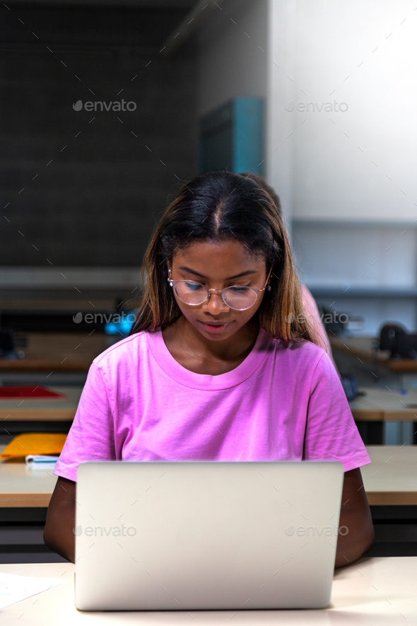 African american college student using laptop in class. Teen black high ...