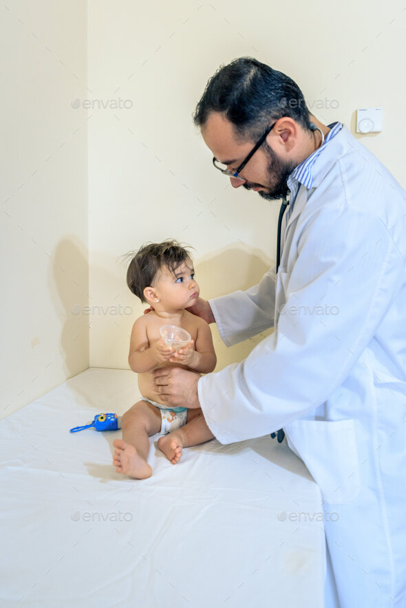 Doctor watching a baby Stock Photo by yosss1 | PhotoDune