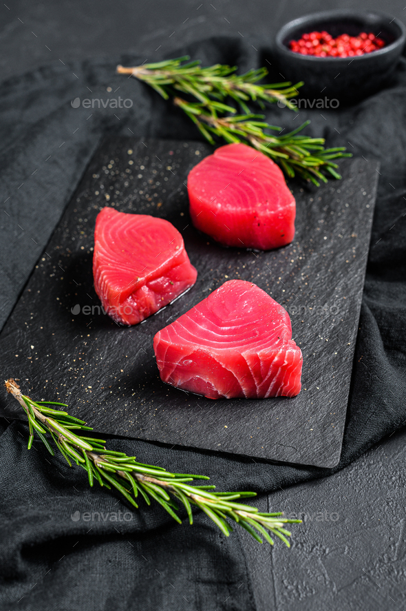 Raw red tuna steak. Black background. Top view Stock Photo by composter-box