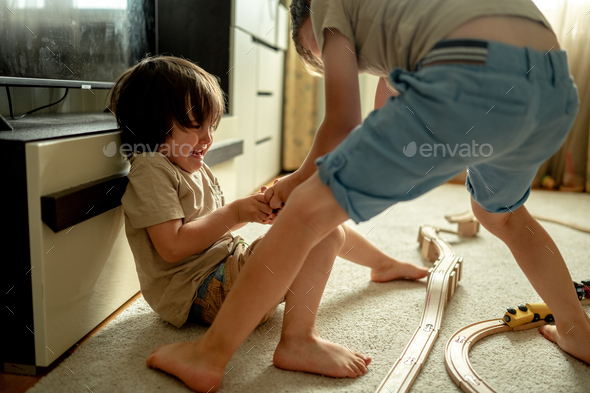 Two small children, brothers fighting over a toy. Conflict between ...