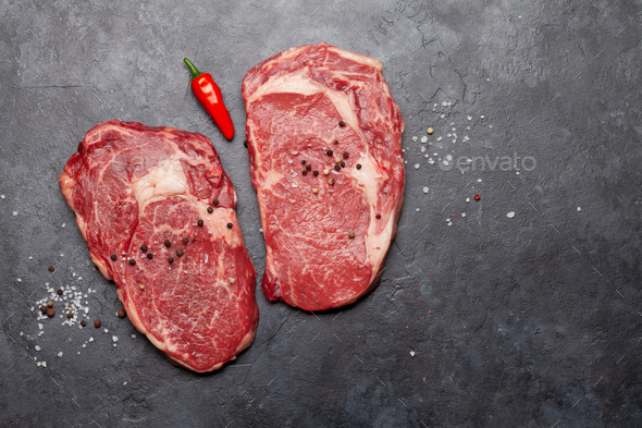Two raw ribeye beef steaks Stock Photo by karandaev | PhotoDune