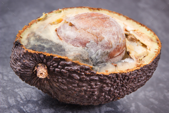 Inedible avocado with mold. Dark background. Unhealthy food Stock Photo ...