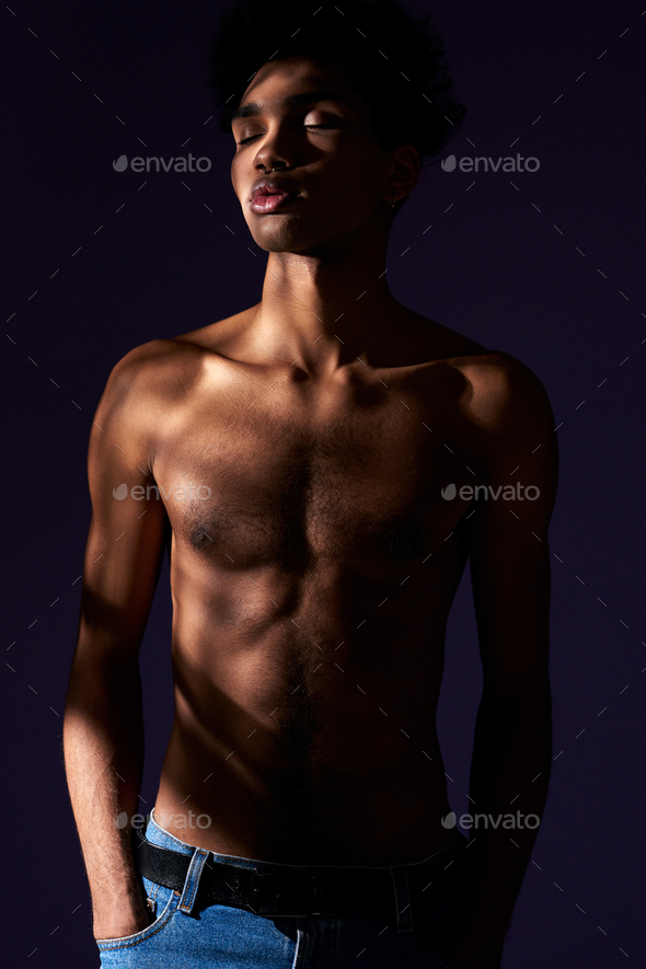 Portrait of transgender model with closed eyes stand in casual pose in ...