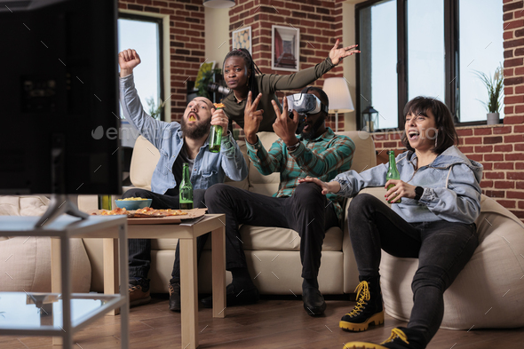 Smiling friends feeling cheerful about winning video games Stock Photo ...