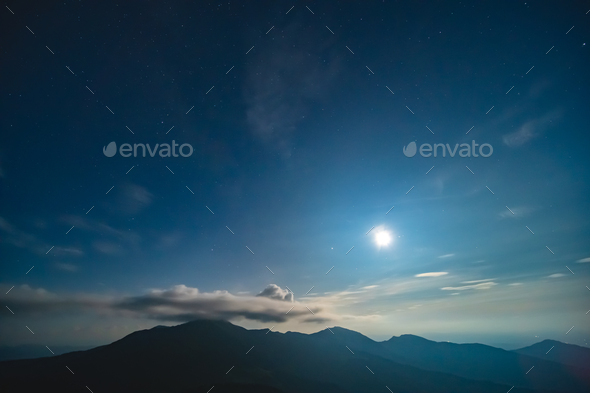The bright moon in the starry sky on the cloud background. Stock Photo ...