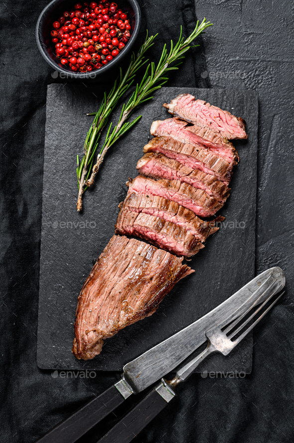 Grill Restaurant Beef Menu - Flank Steak on a black stone Board. Black ...