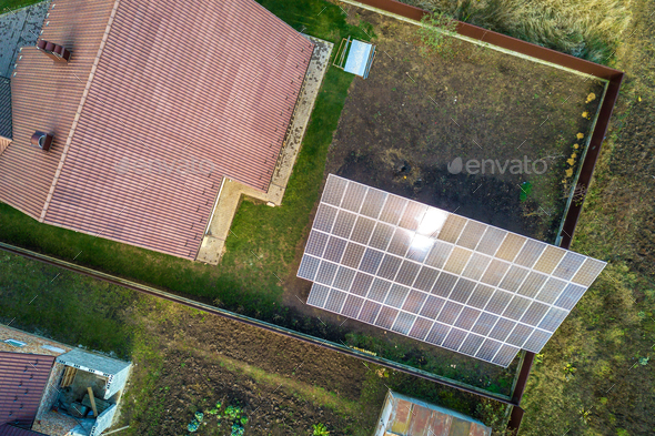 Aerial view of big blue solar panel installed on ground structure near ...