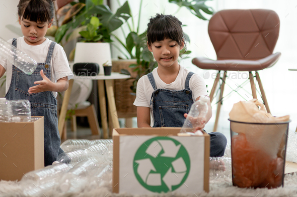 Smiling children having fun while segregating plastic bottles and paper ...