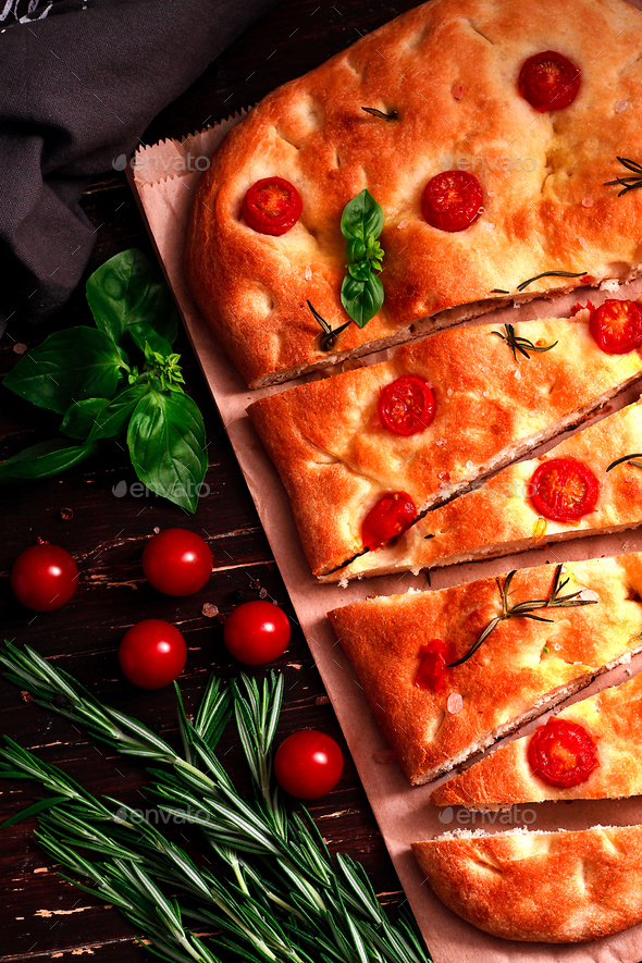 Focaccia, Italian flatbread, with cherry and rosemary, close-up, garlic ...