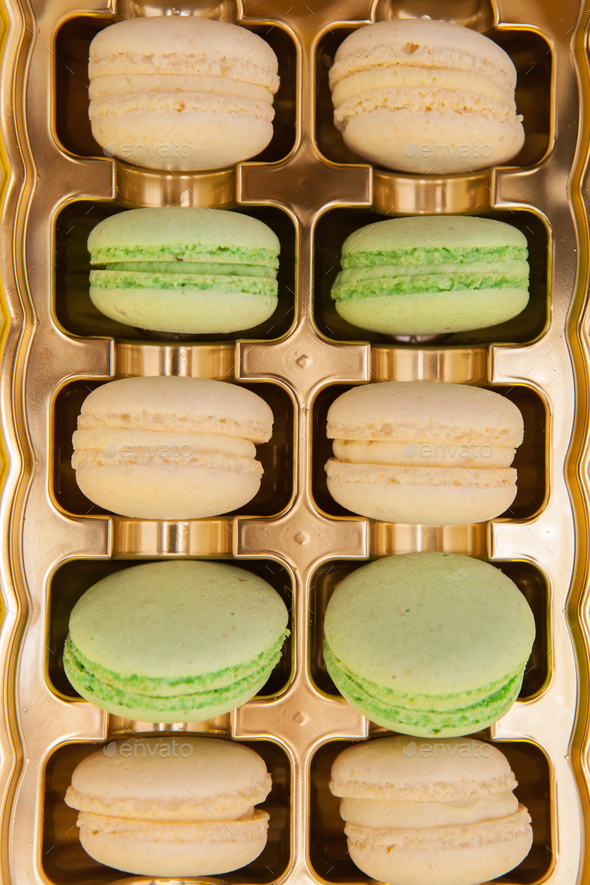 Traditional french sweets macarons in a golden box Stock Photo by DC_Studio