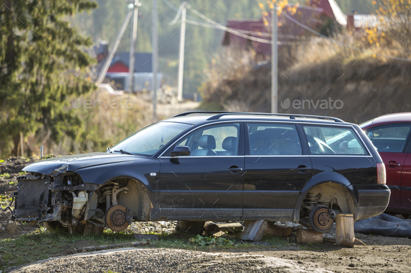 Old forsaken rusty broken trash car after crash accident without wheels ...
