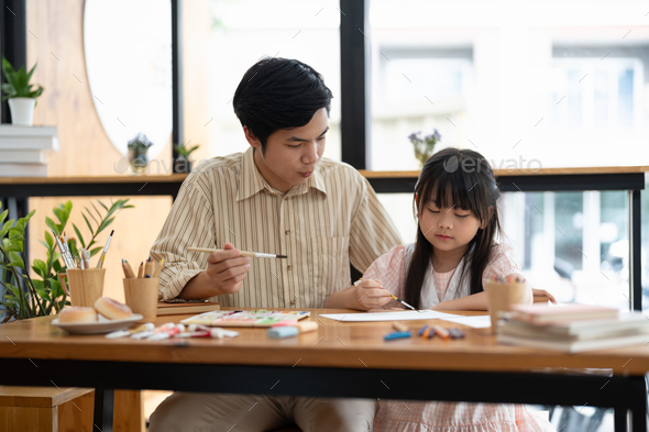 Happy proud asian father and daughter having fun together, drawing and ...