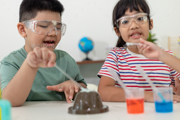Kids repeating and observing a science lab project at home - the baking ...