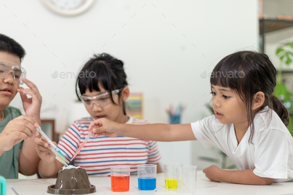 Kids repeating and observing a science lab project at home - the baking ...