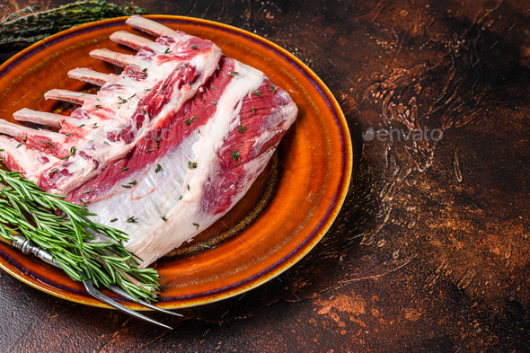 Raw Racks of lamb ready for cooking. Dark background. Top view. Copy ...