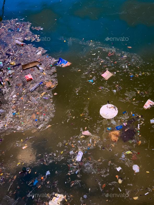 Plastic garbage is swimming on rhe water surface. Garbage at dirty ...
