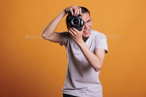 Photographer taking portrait photo on professional dslr camera Stock ...