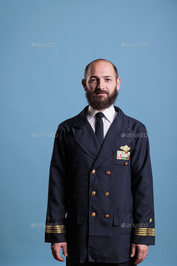 Smiling airplane captain wearing uniform Stock Photo by DC_Studio ...