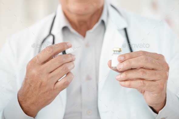 Cropped shot of an unrecognisable doctor holding a syringe and vaccine ...