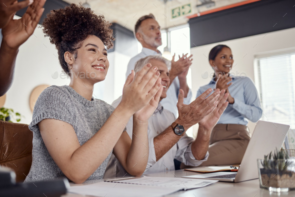 Shot of a group of businesspeople clapping during a conference in a ...
