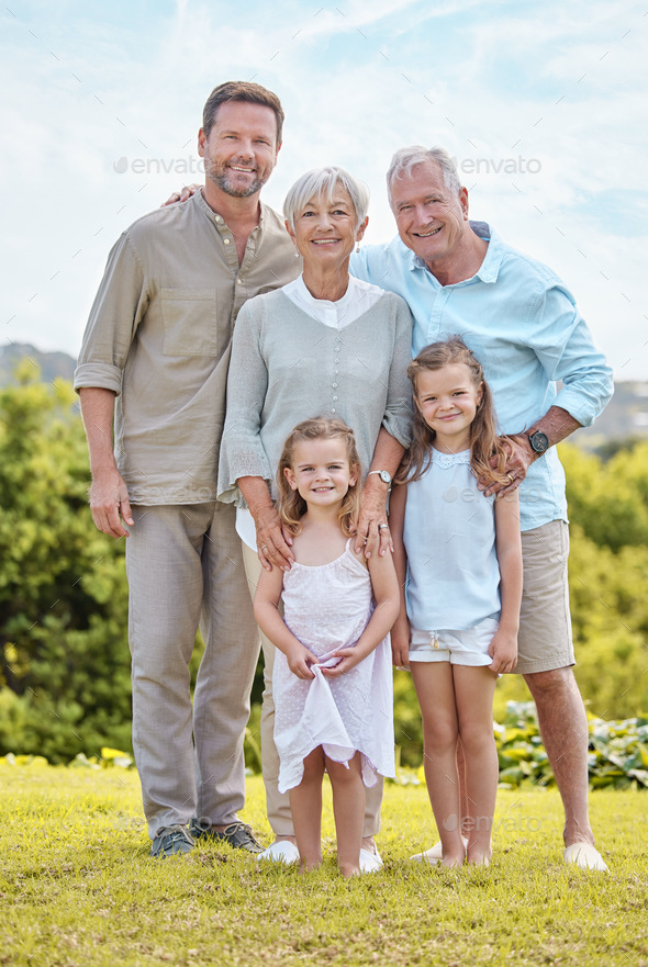 .Shot of a family standing together in a park. Stock Photo by ...