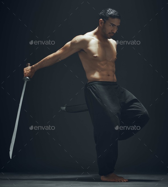 Full length shot of a handsome young man standing alone in the studio ...